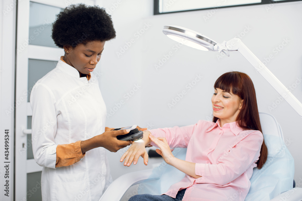 Skin cancer and melanoma prevention concept. Young confident African ...