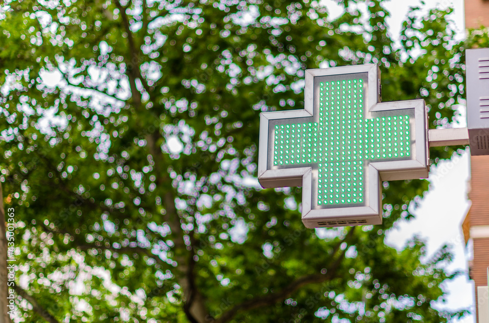 Green cross sign indicating pharmacy Stock Photo | Adobe Stock