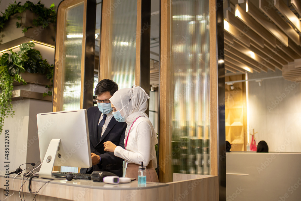 young Asian reception team hotel front desk welcoming . Asian reception ...