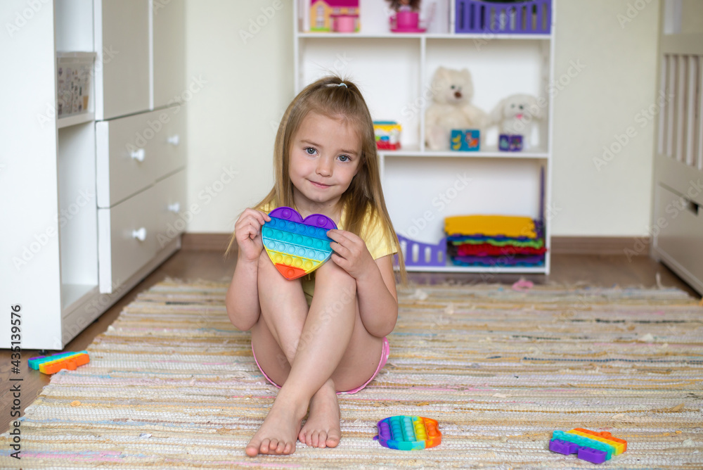 popit toy, a child plays with a flapping fidget. popular children's ...