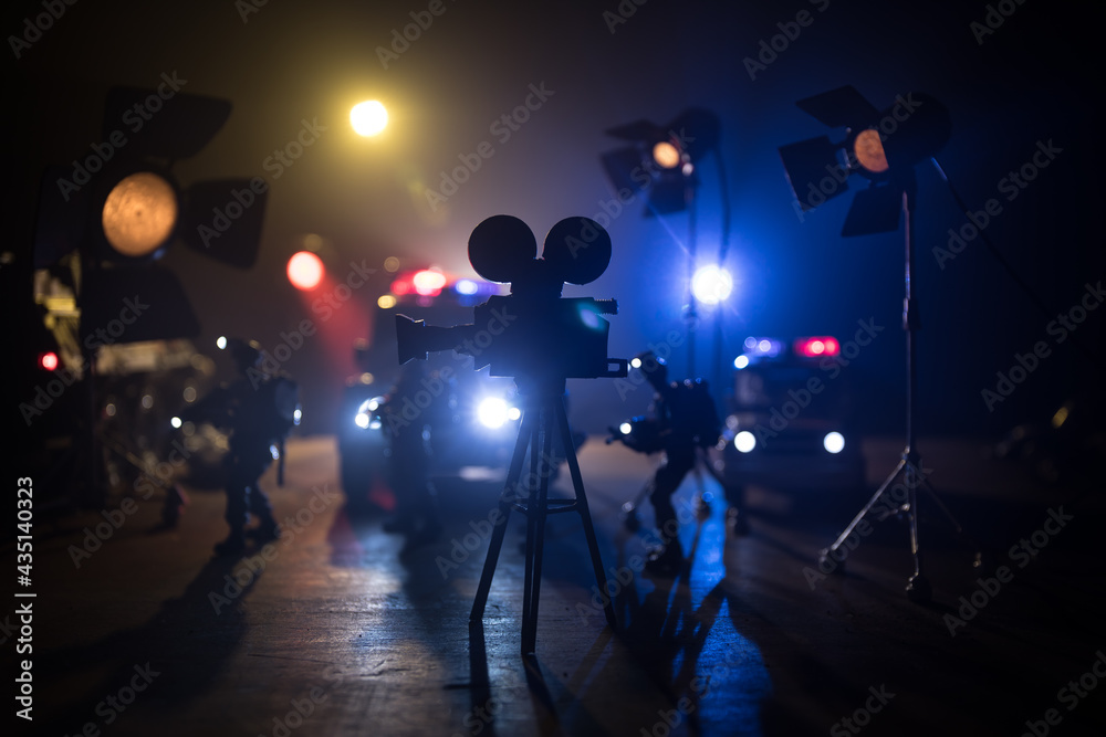 Action movie concept. Police cars and miniature movie set on dark toned ...