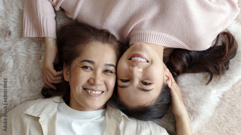 Attractive beautiful cheerful authentic real family two people laying ...