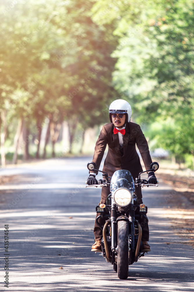 Rider riding modern classic motorcycle with suit look like gentleman ...