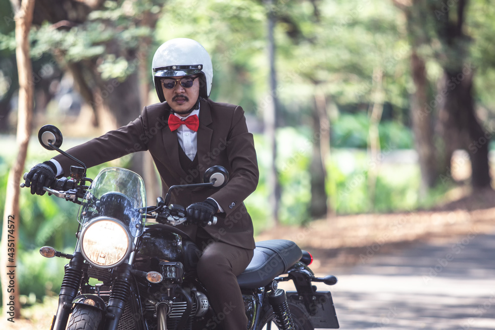 Rider riding modern classic motorcycle with suit look like gentleman ...