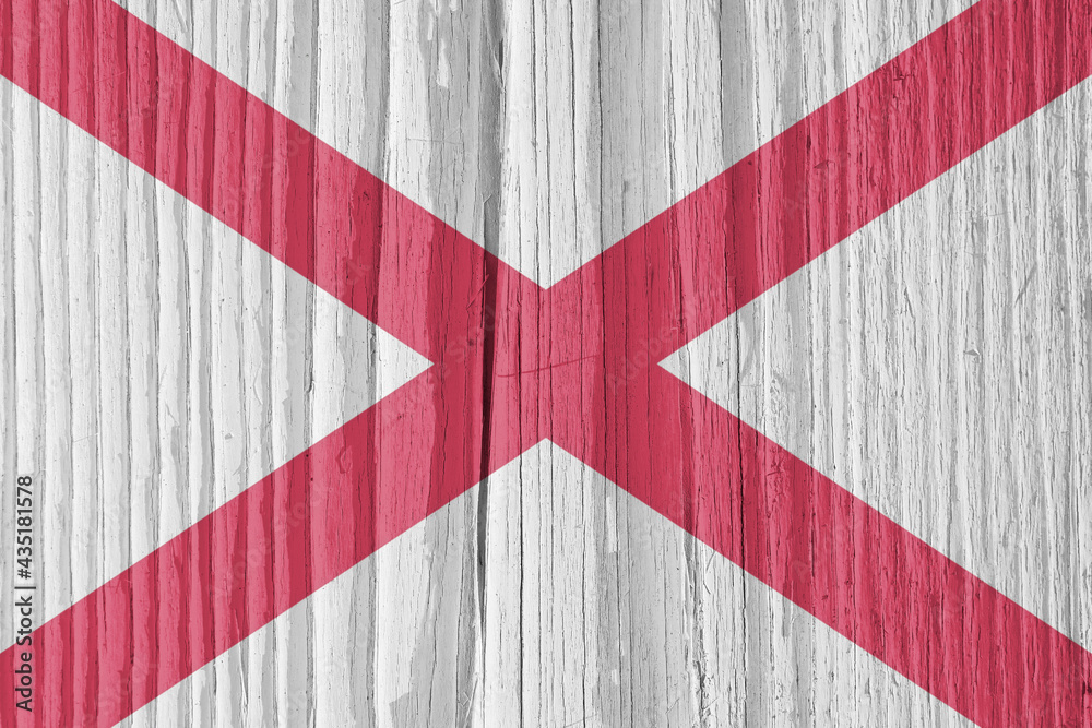 Alabama state flag on dry wooden surface. Light, pale, faded paints ...