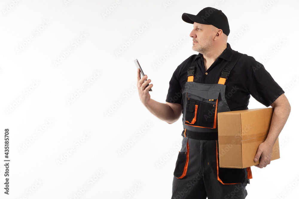 Deliveryman in working uniform. The courier delivers the package. Man ...
