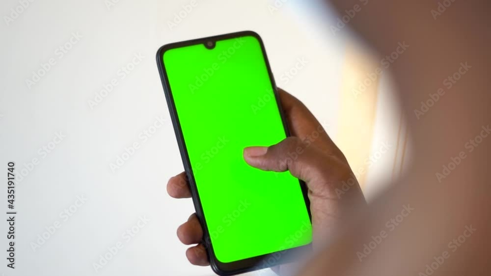 Closeup shot of hand using mobile phone with Green screen, Finger ...