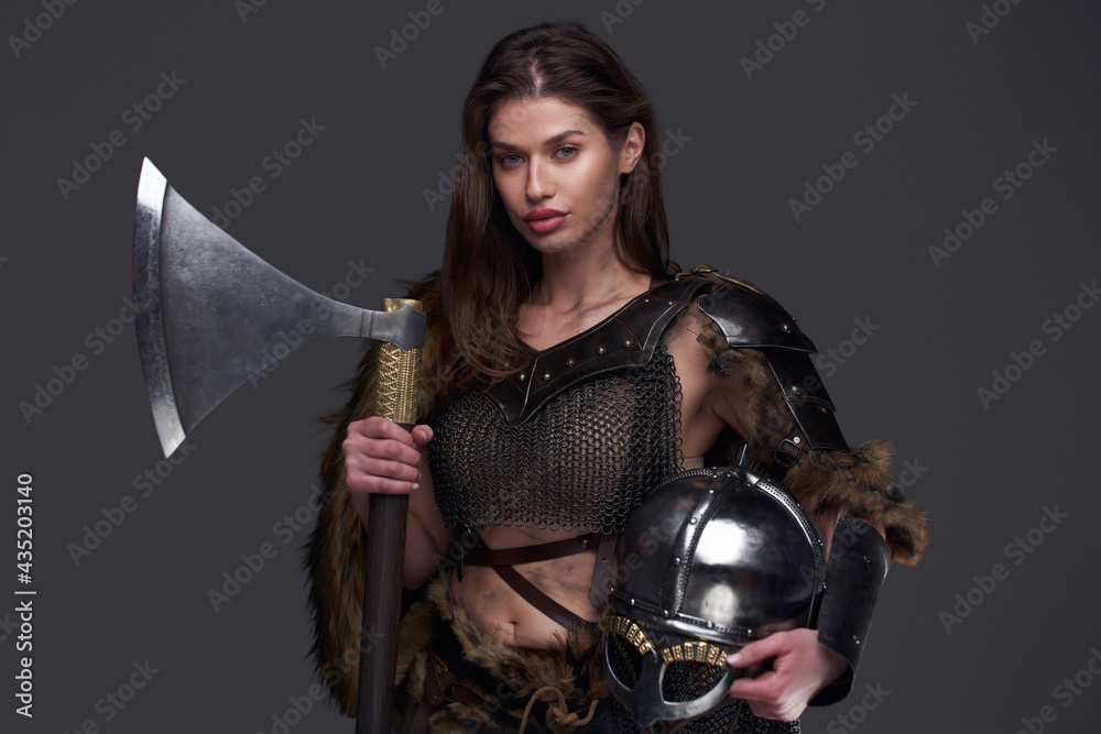 Warlike northern woman with brown hairs and axe Stock Photo | Adobe Stock
