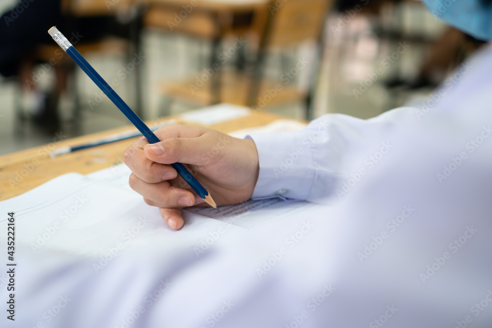 Hands of Asian students group learning and concentrate writing test in ...