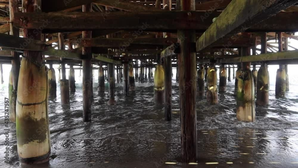 Waves Hitting Wooden Pier Pilings under a Pier Showing the Support ...