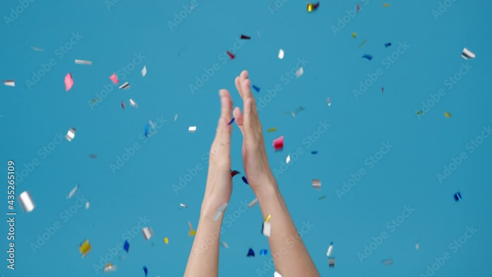 Young girl show hand clapping applause under confetti rain and ...