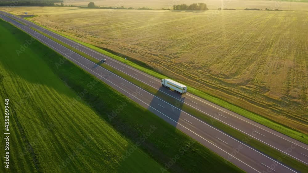 AERIAL: Flying along a cargo truck transporting goods across the ...