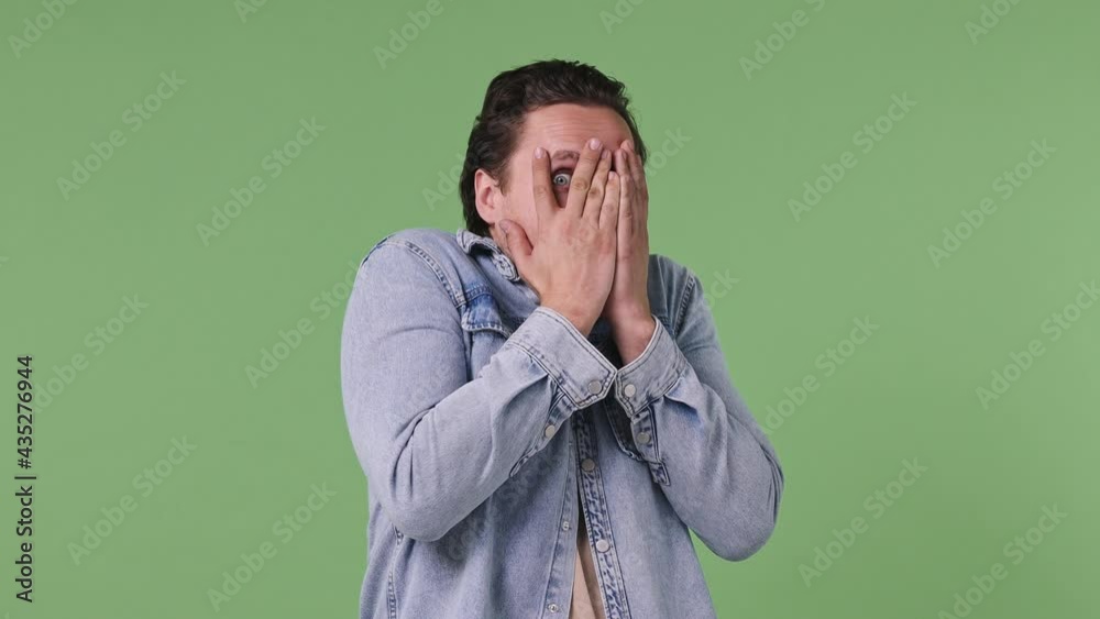 Scared surprised shocked young brunet blue eyed man 20s years old wears ...