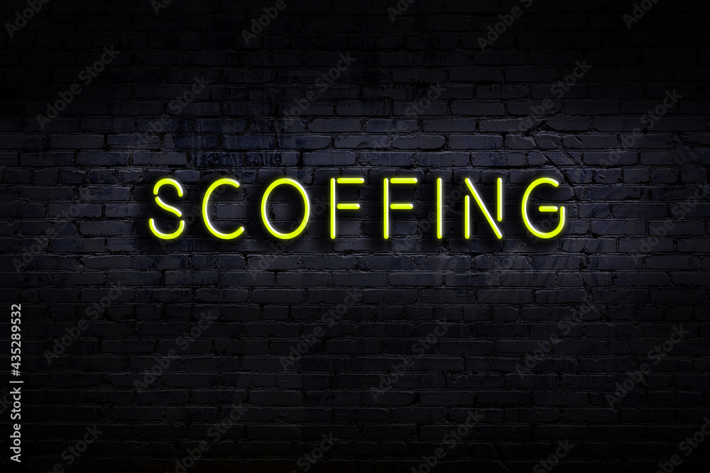 Neon sign. Word scoffing against brick wall. Night view Stock ...