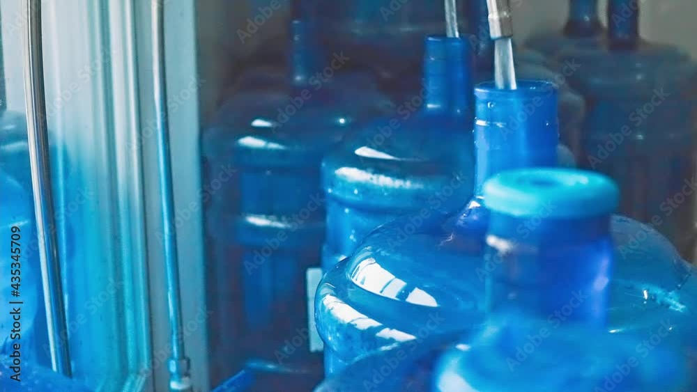 Safe clean purified drinking water. Refilling containers at a Water ...