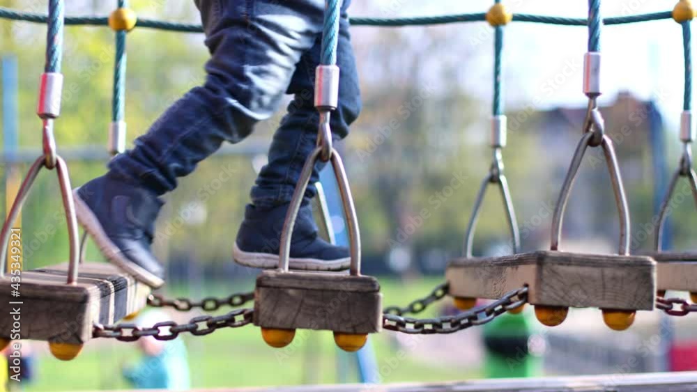 child's kid's legs in blue jeans and boots passing obstacle course ...