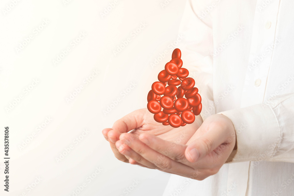 Blood donation. Human hands holding blood drop shape of red blood cells ...