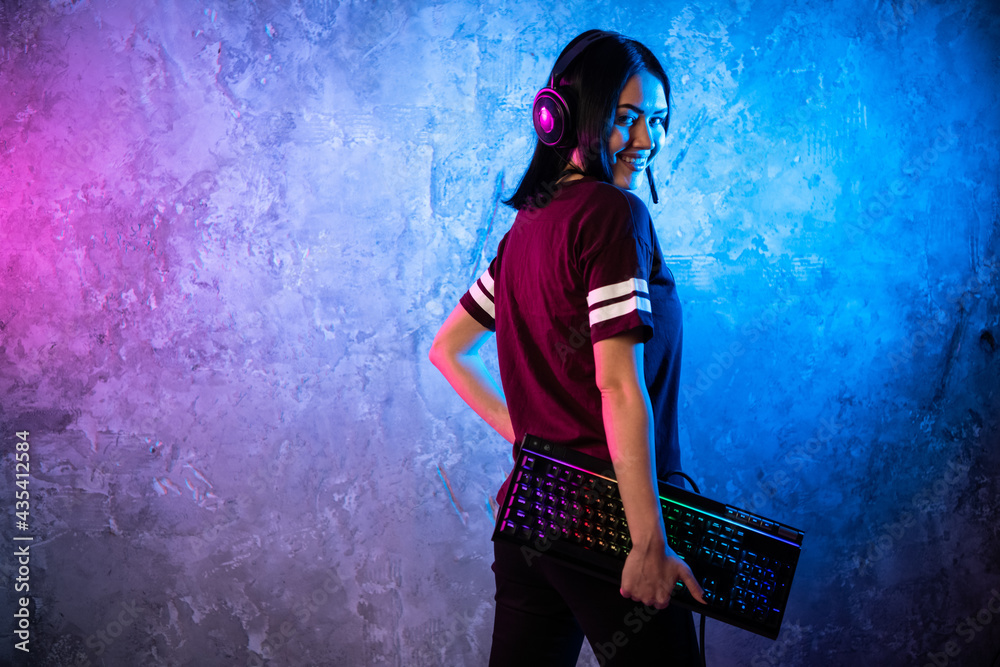 Female esports gamer posing with a gaming gear in neon light. Streamer ...