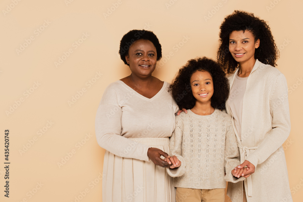 african american grandmother and daughter holding hands with ...