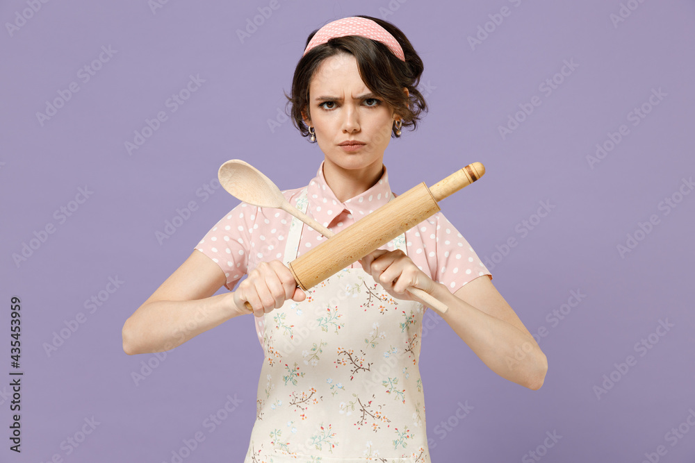 Young sad serious strict housewife housekeeper chef cook baker woman in pink apron do stop ...