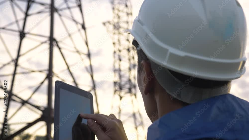 Electric energy concept, technology. engineer works with a tablet ...