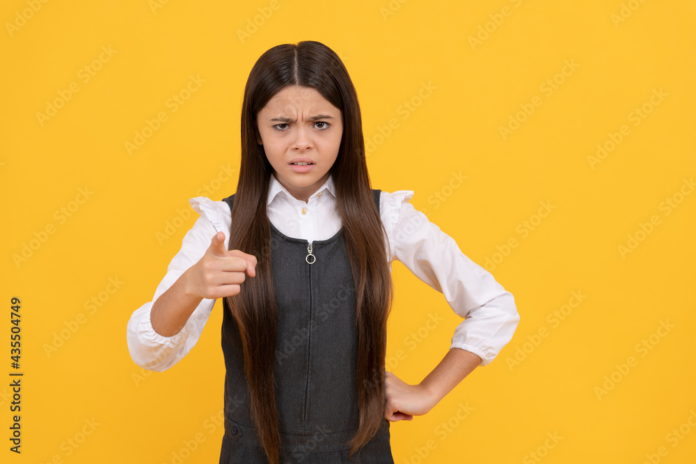 Angry kid in school uniform point accusing finger yellow background ...