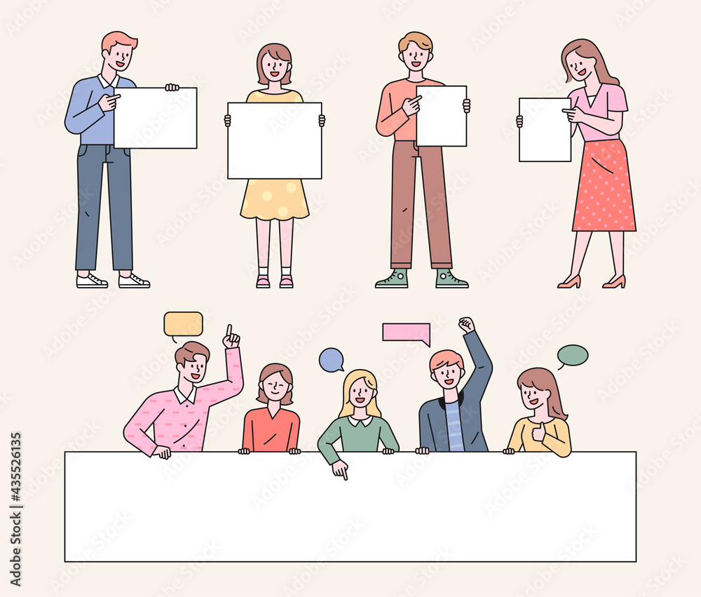 People are standing holding a white board. People are making comments ...