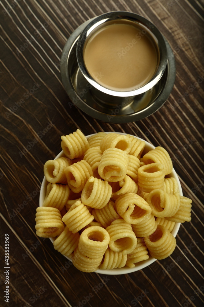Indian butter chakli, chakkli, murukku served with milk tea. Stock ...