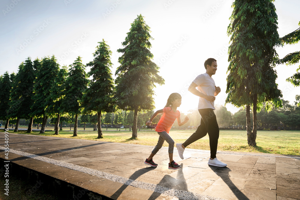 asian father and little daughter do exercises running outdoor. Healthy ...