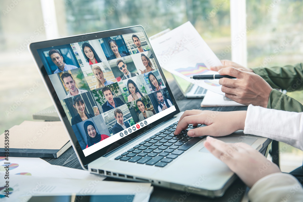 Multiethnic business team using laptop for a online meeting in video ...