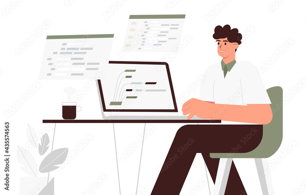 Young guy programmer works on a laptop at the table. The man writes ...