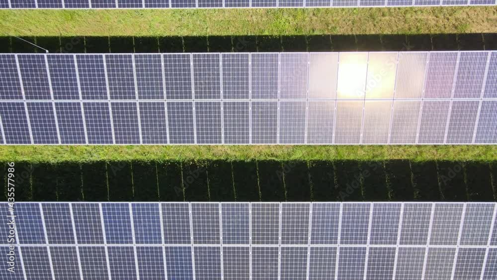 Rising aerial view over solar panel under direct sunlight, arranged ...