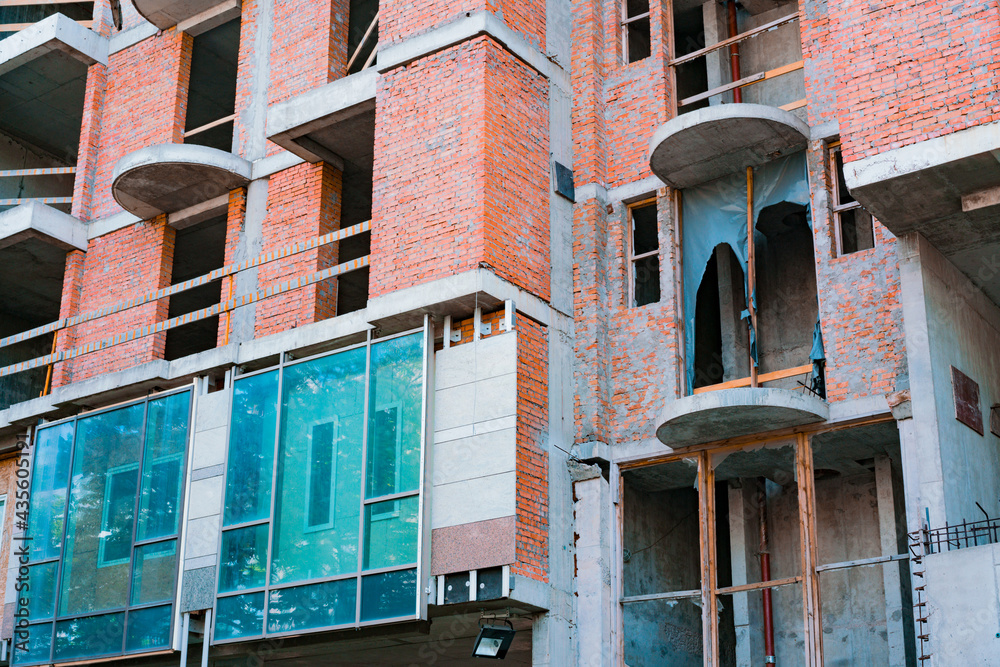 Foto de Abandoned incomplete building with red brick, rounded concrete ...