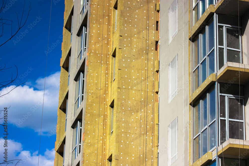 Warming of a multi-story residential building facade with a mineral ...