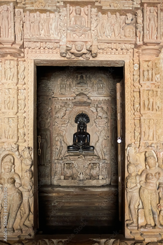 Black deity statue and sculptures in Parshvanath Temple, a Jain temple ...