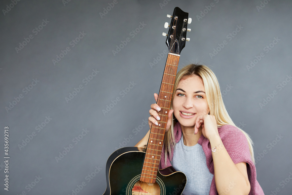 Happiness young woman play music with acoustic guitar on blue ...