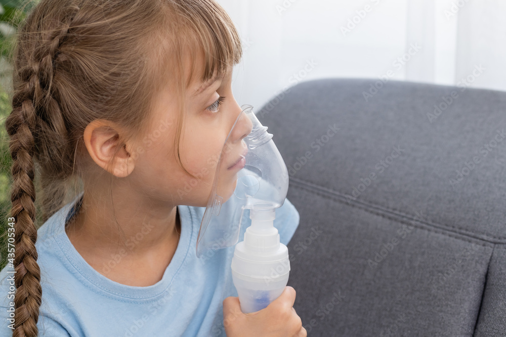 Little girl making inhalation with nebulizer at home. child asthma ...