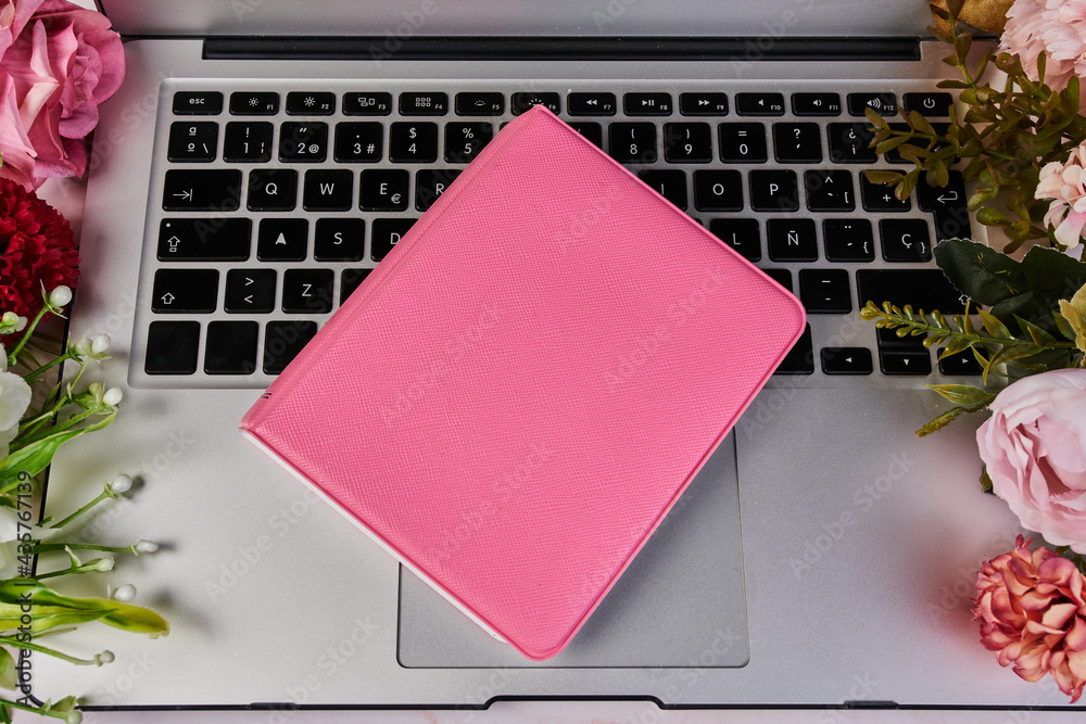 Computadora portátil con un álbum de fotos de color rosa, concepto ...