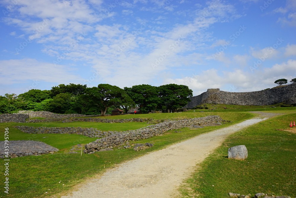 Green field and stone wall at Nakijinjo castle ruins in Okinawa, Japan ...