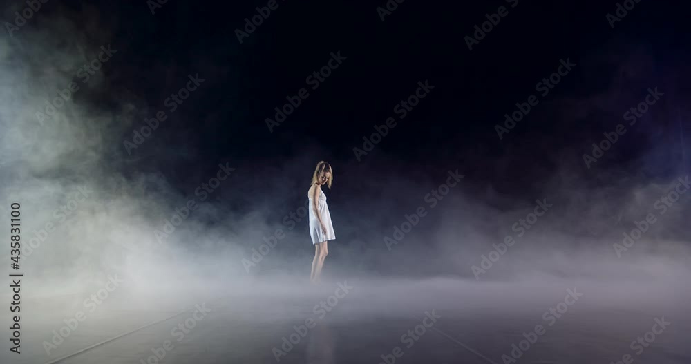 Vidéo Stock A sweet, gentle and fragile girl walks in the fog, as if ...