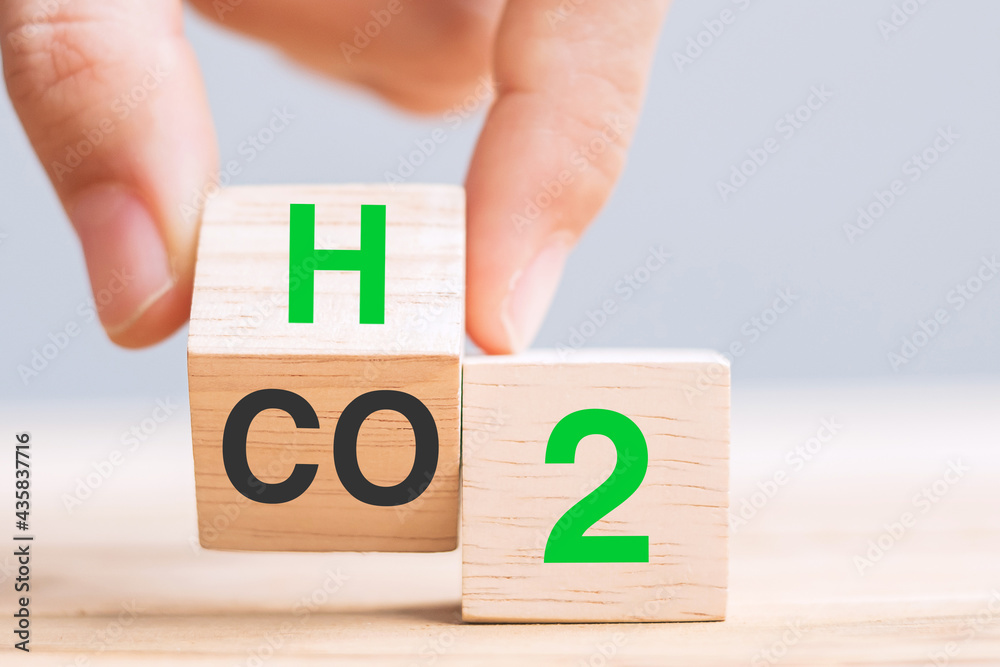 hand flipping wooden cube blocks with CO2 (Carbon dioxide), change to ...