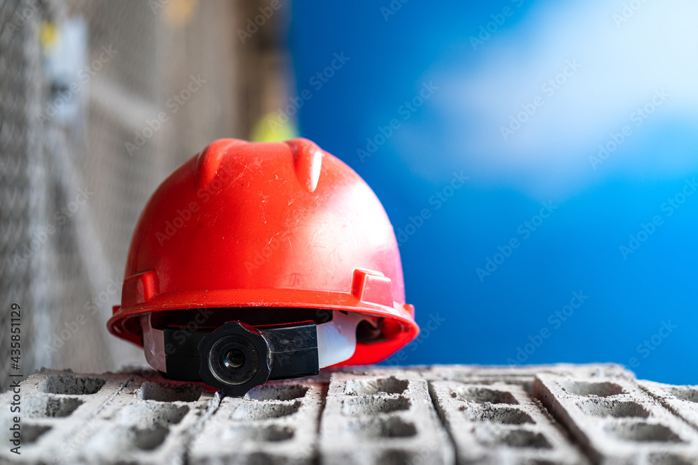 A red safety working helmet for supervisor PIC (person in charge) is ...