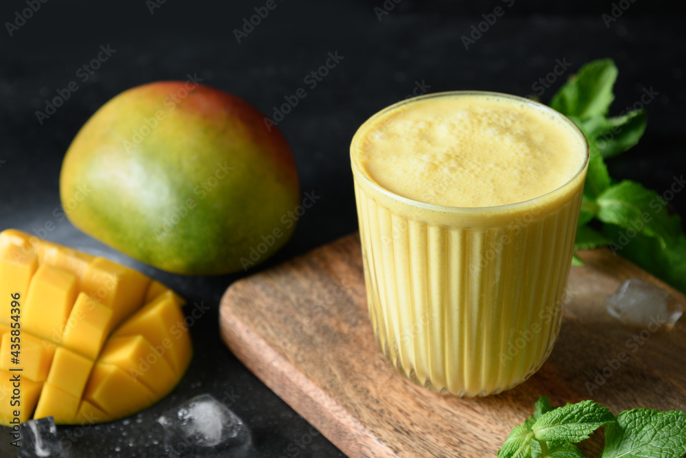 Turmeric lassie or mango lassi on black background. Indian cold drink ...