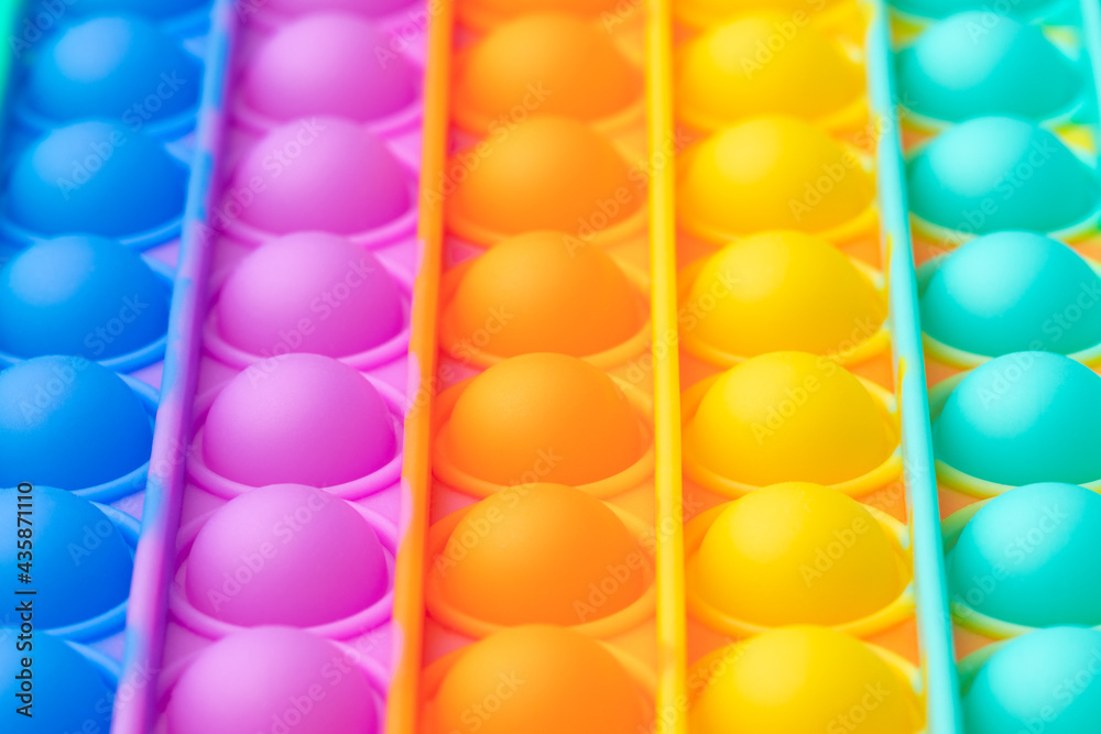 Pop it fidget. Colorful toy push pop it. Close up of antistress sensory ...