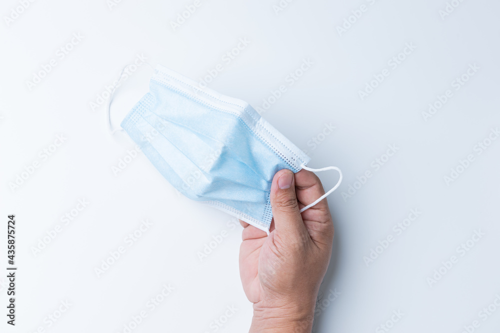Top view hand man holding medical masks isolated on a white background ...