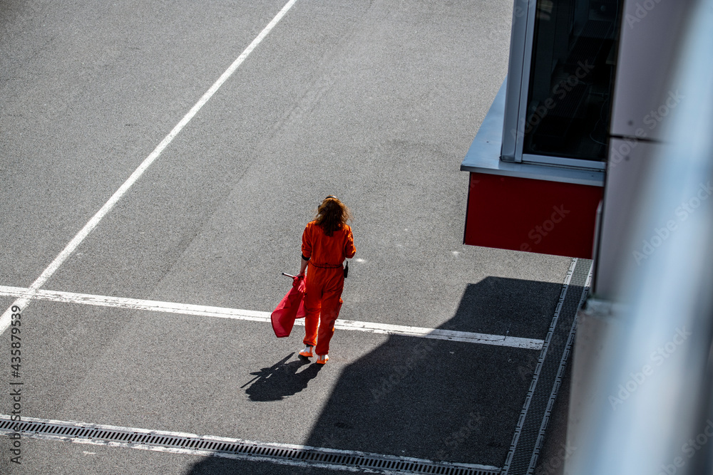 racetrack staff who monitor safety during sports car races on the track ...