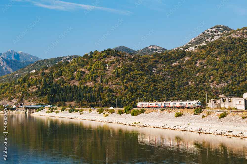 View at a dam with a train at railway Bar - Belgrade at Lake Skadar in ...