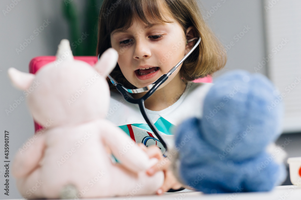 Child playing hospital game pretending to be doctor, veterinarian ...