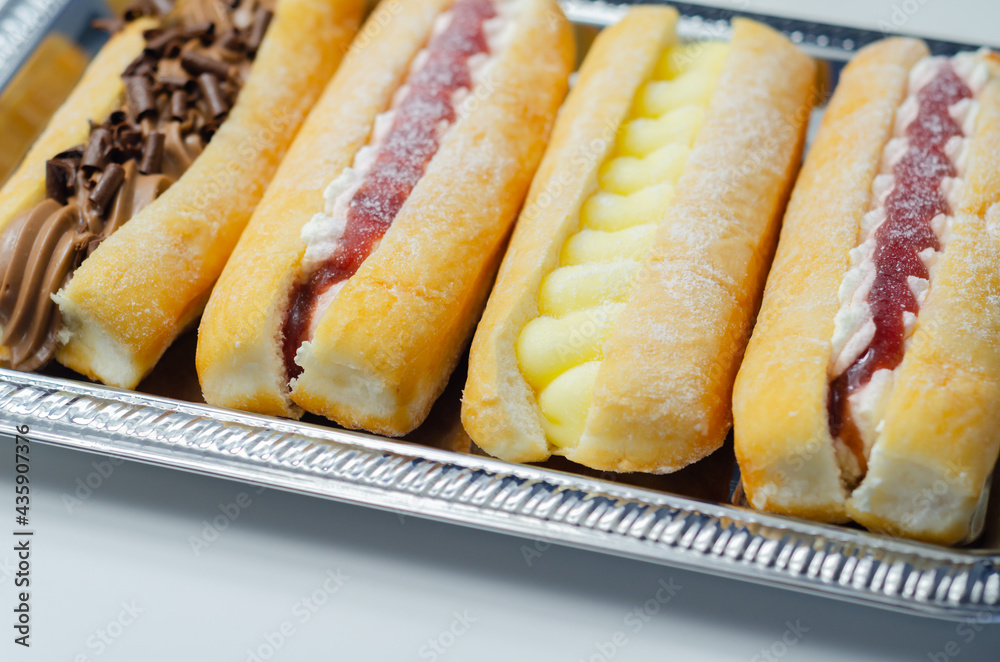 Mixed finger donuts filling chocolate, custard, jam and whipped cream ...