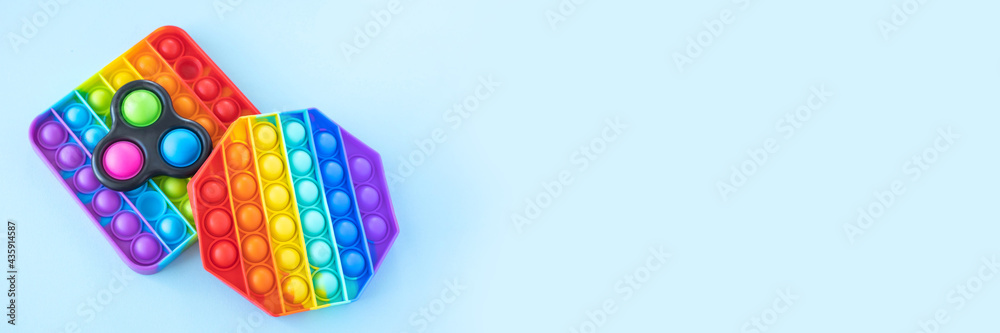 Colorful anti-stress fidget push pop it sensory toys isolated on blue ...